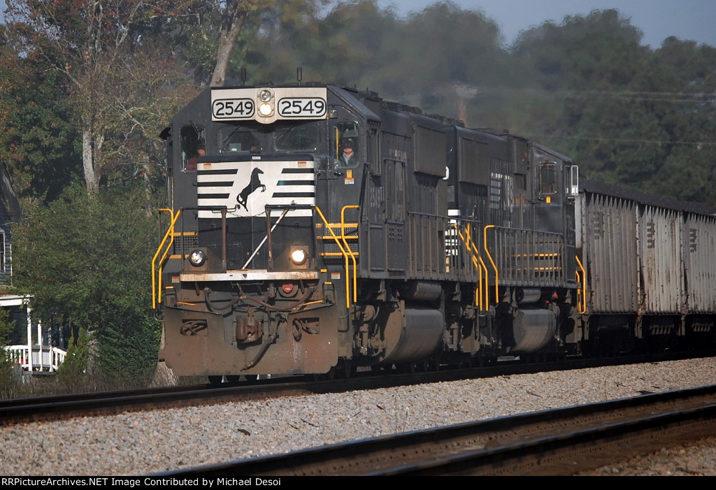 NS SD-70 #2549 is in charge of an eastbound coal train about to cross Main St.